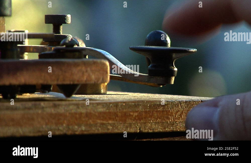 Historical old telegraph operator taps out message using morse code ...