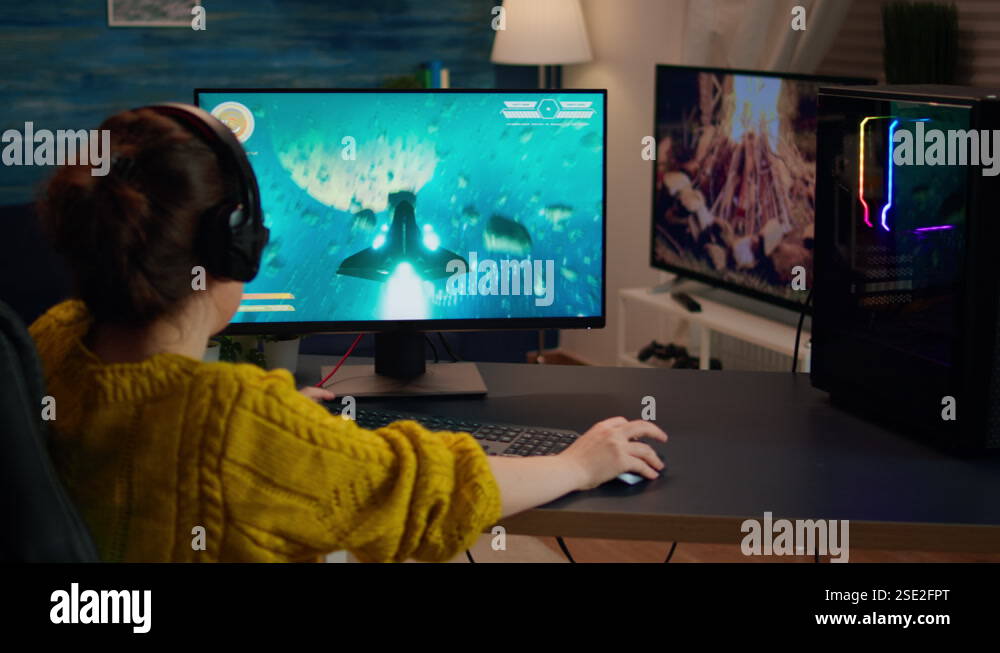 Over the shoulder woman gamer playing online shooter game Stock Video ...