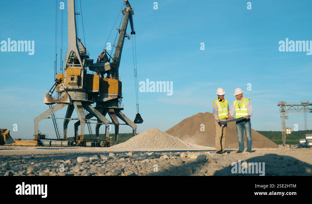 Quarry zone with industrial machines and two engineers Stock Video ...