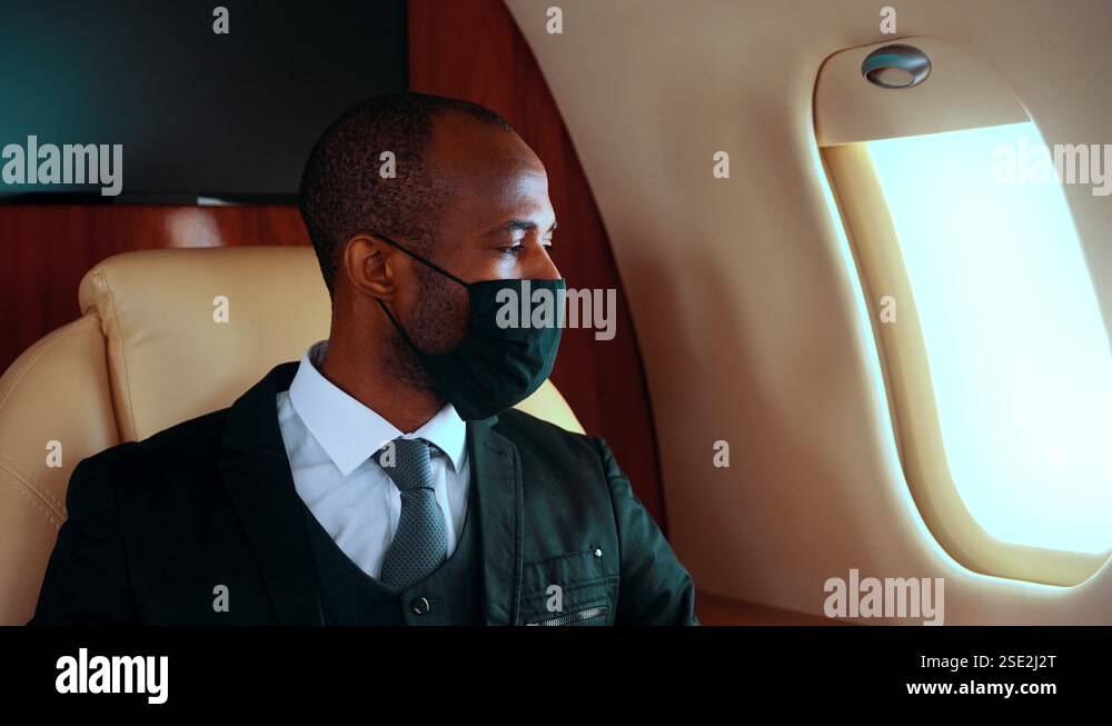Businessman wearing protective face mask on airplane Stock Video ...
