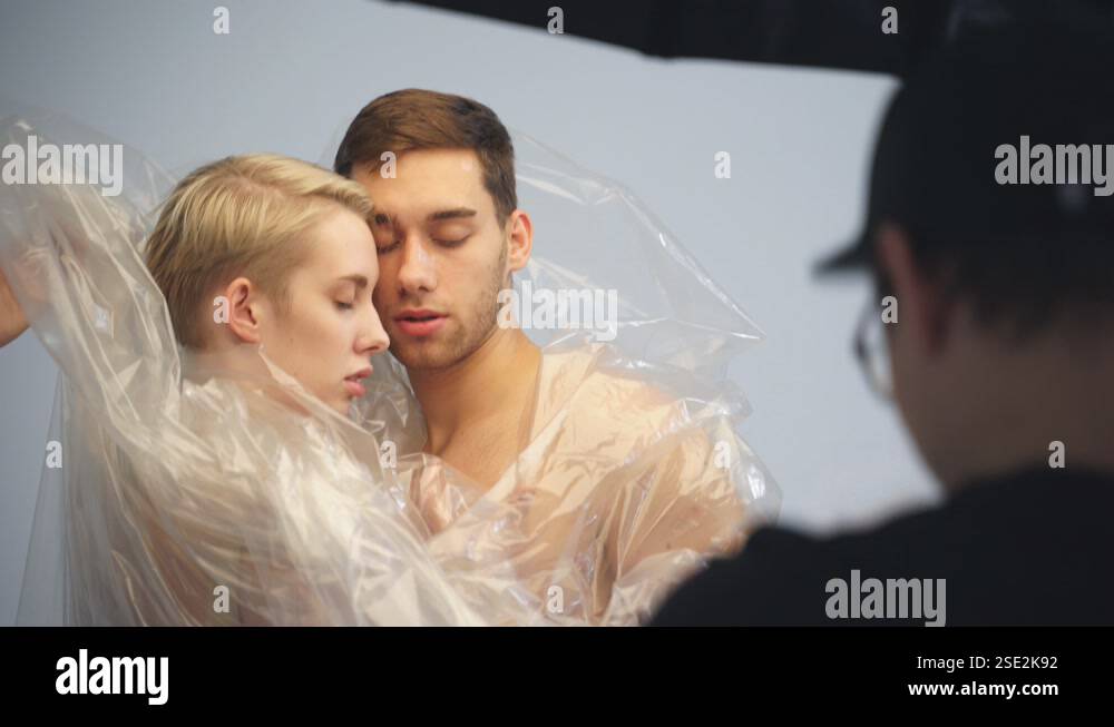 Photographer conducts photo session for a young couple in plastic ...