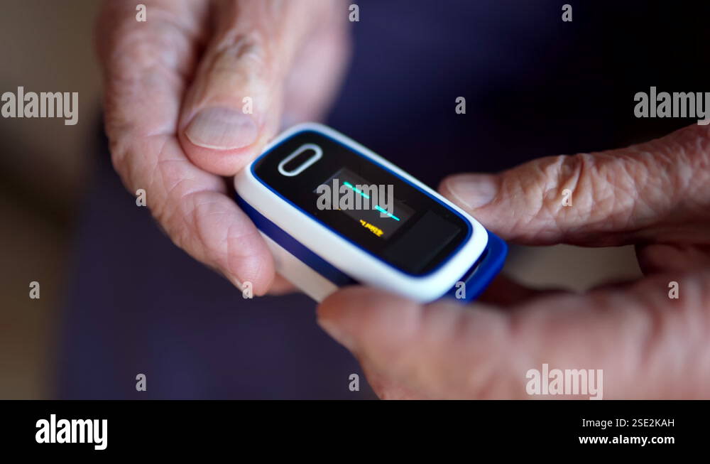 Old man using digital pulse oximeter for controlling oxygen saturation ...