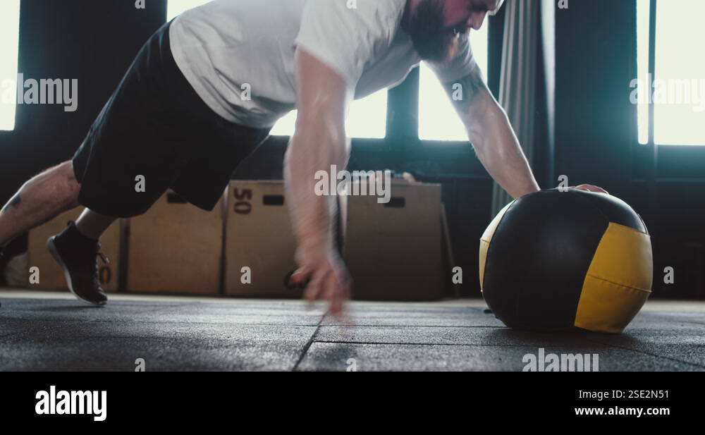 Staying fit. Side view young bearded muscular Caucasian sportsman doing ...