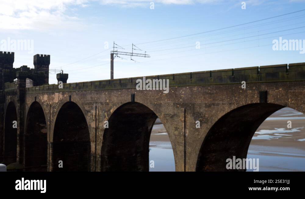 Public train crossing Runcorn bridge old castle turret building tower ...