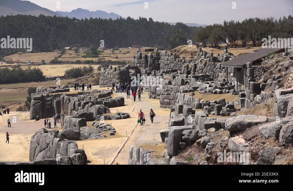 Tourists wander around the ancient Incan site, Sacsayhuamán in Peru ...