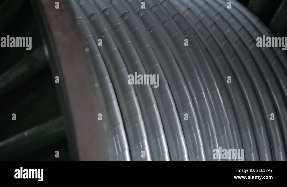 Close-up of the winding of a high-voltage electric cable on a coil in ...