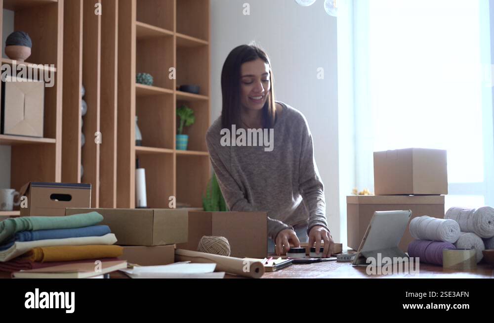 Online store owner packing the order for shipping to customer Stock ...