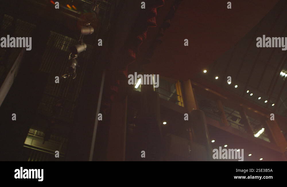 Low angle view of lighting and stage rigging and catwalks overhead as ...