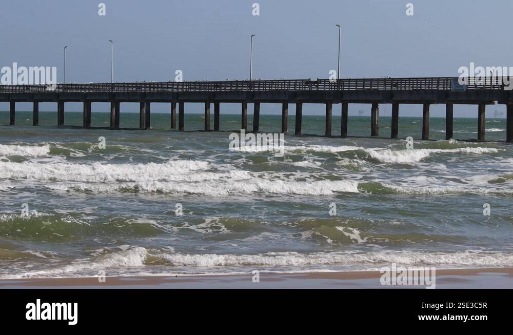 Pan of Bob Hall Pier into the Gulf of Mexico at North Padre Island ...