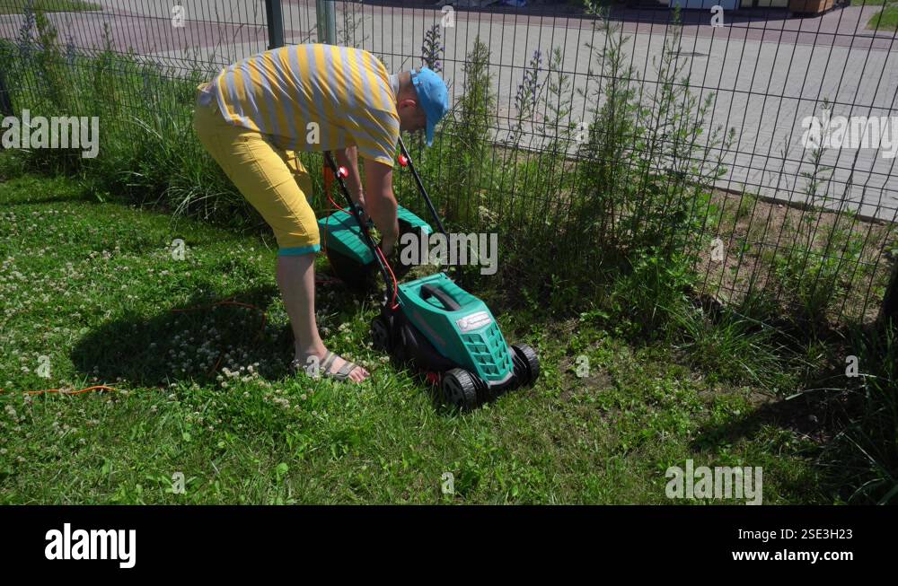Gardener man pour cut grass over fence. Careless guy mess. Gimbal ...