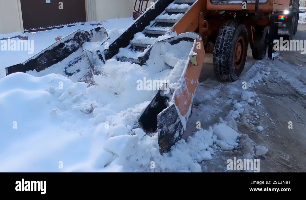 The work of snow plows on cleaning and moving snow in urban conditions ...