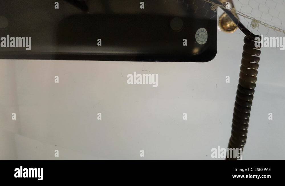 Shot of a telephone from underneath a glass table being hanged up. Part ...