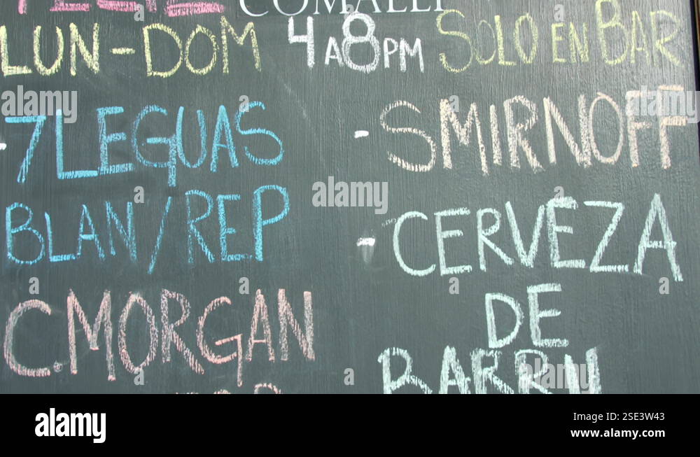 Vertical blackboard with wooden frame with colorful text in Spanish ...