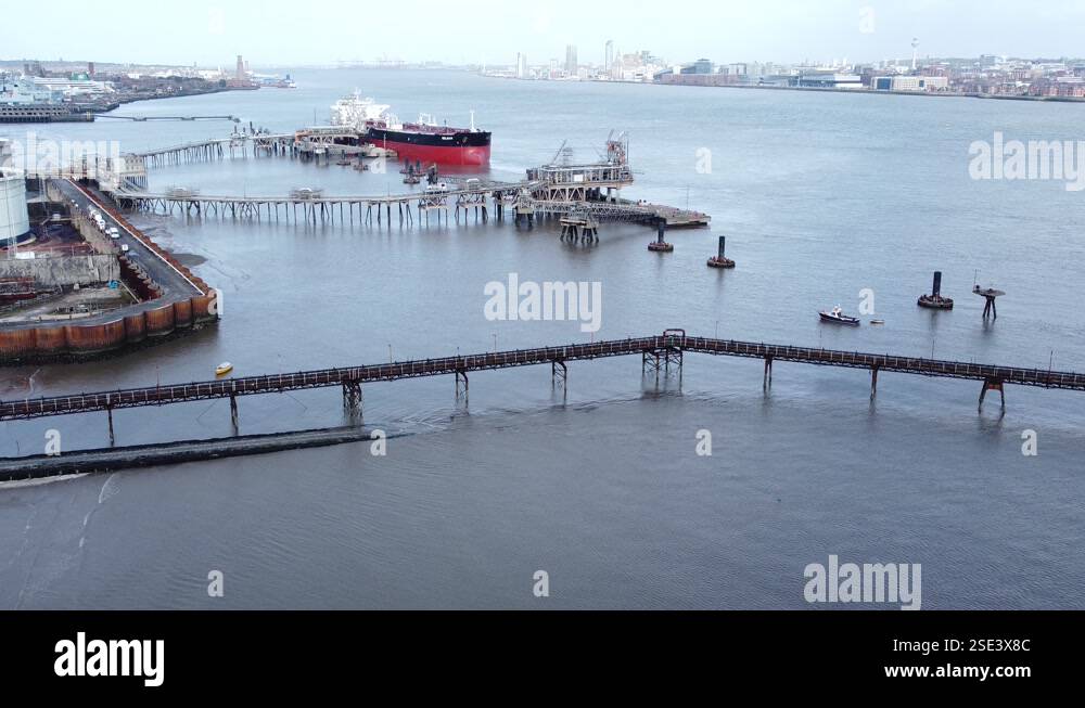 Shipping tanker loading at Tranmere Shell oil industrial harbour ...
