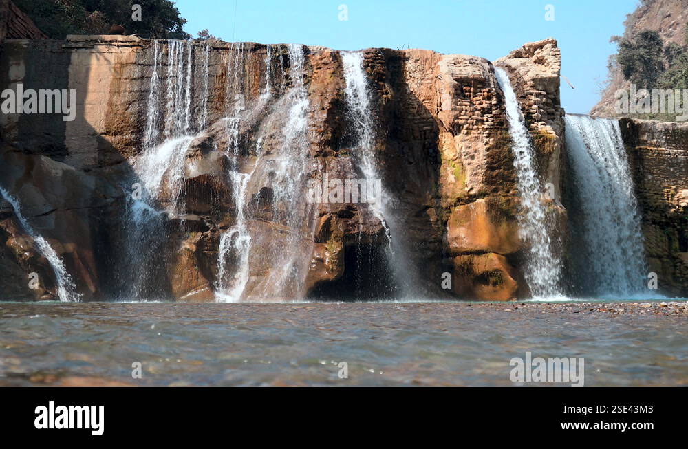 Waterfall cascade through the rocky trails in forest wide shot Stock ...