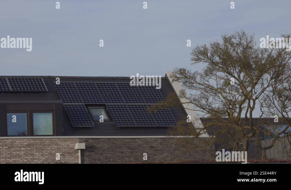 Slow panning shot along solar panels on UK residential housing Stock ...