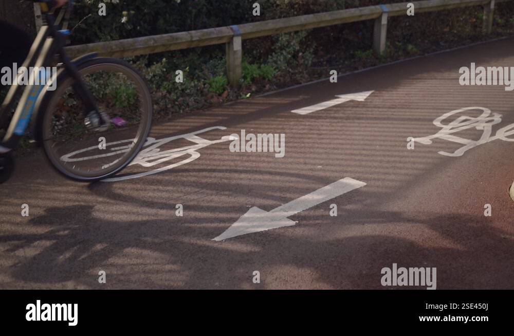 Cyclist on a cycle path way with bike sign markings Stock Video Footage ...