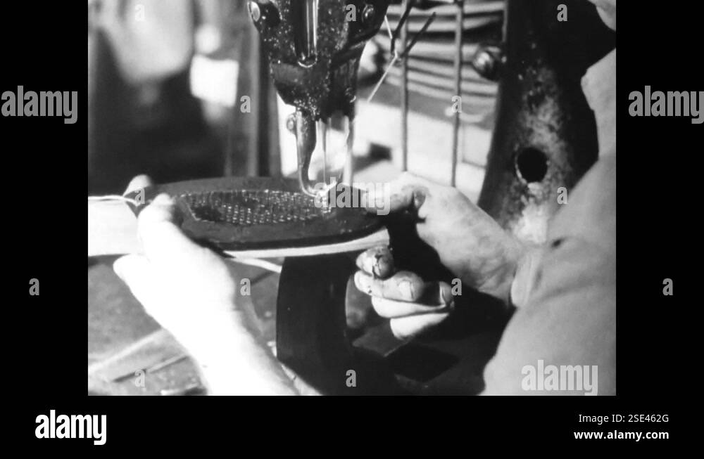 Male Workers In Factory Refurbishing Old Shoes And Boots For U.S. Army ...