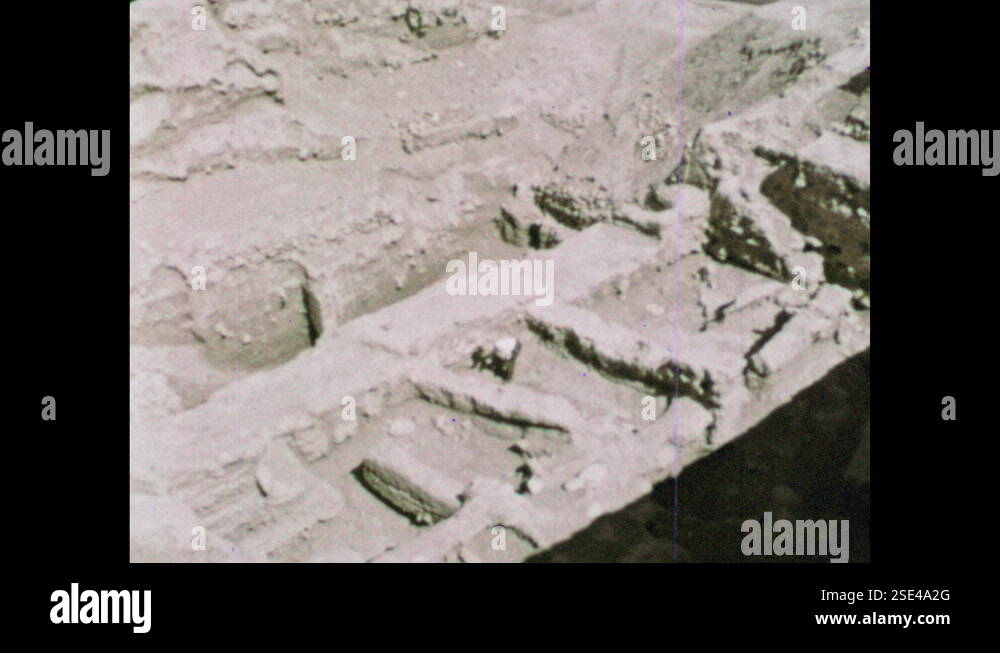 1960s: Man stands looking at ancient ruins in city of Jericho ...
