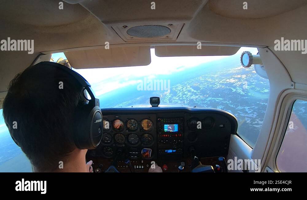 Pilot is turning the plane, tilted view outside of the cockpit, sunset ...
