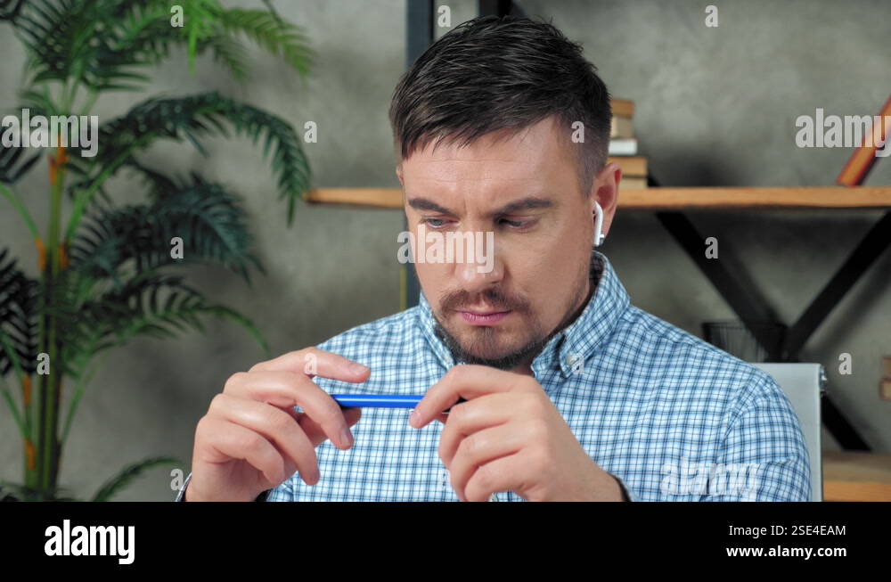 Close up thoughtful teacher wear earphones in home office think ...