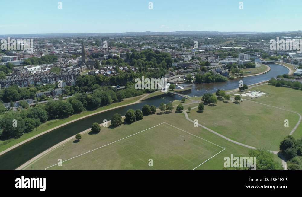 Exeter skyline aerial encapsulating playing fields, parks, the river ...
