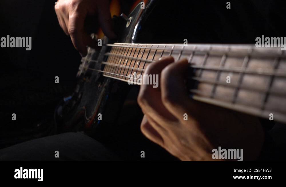 Musician playing electric bass guitar at studio . closeup Stock Video ...