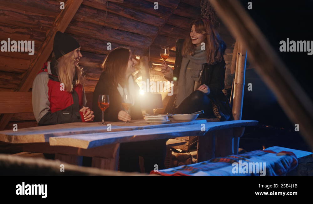 Young women on winter vacation. Having fun in the mountain cottage ...