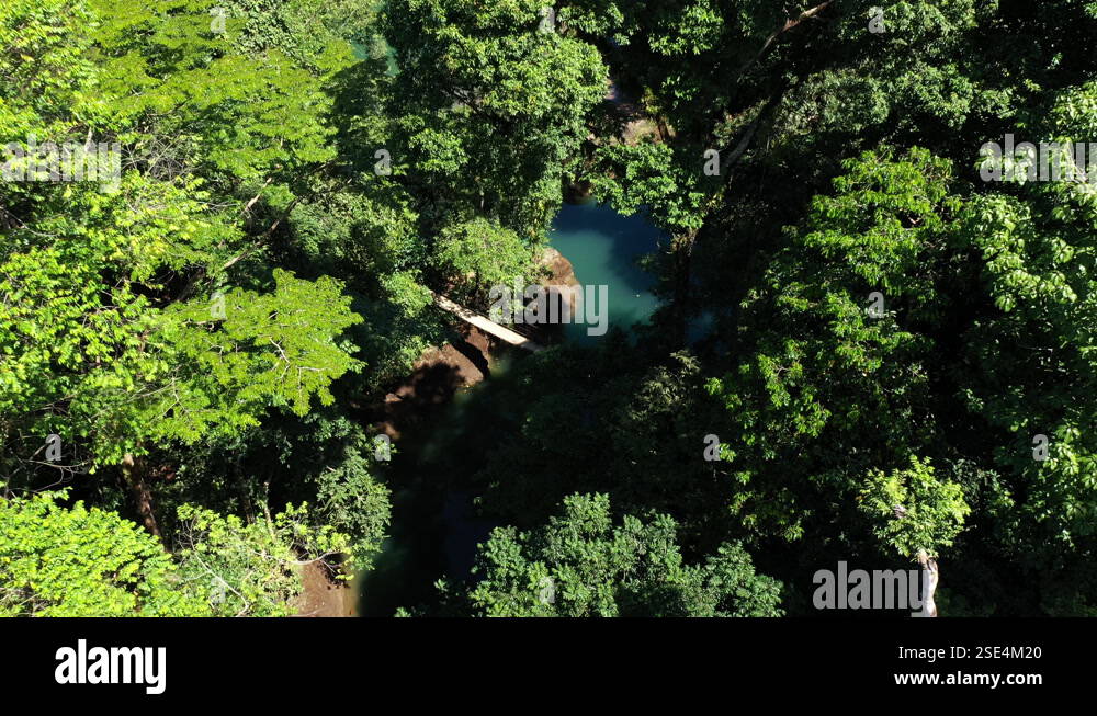 Suspension bridge over blue water river rio agujitas Costa Rica Drake ...