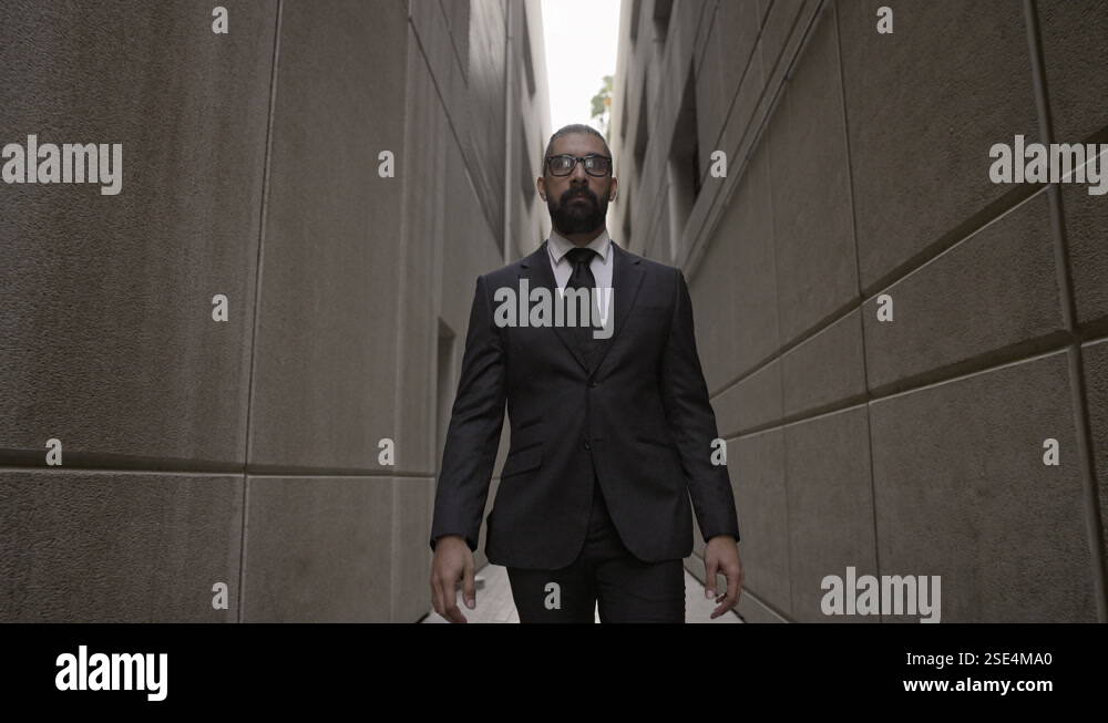 Young Man In Business Clothes Walks Down Narrow Street Between Two ...