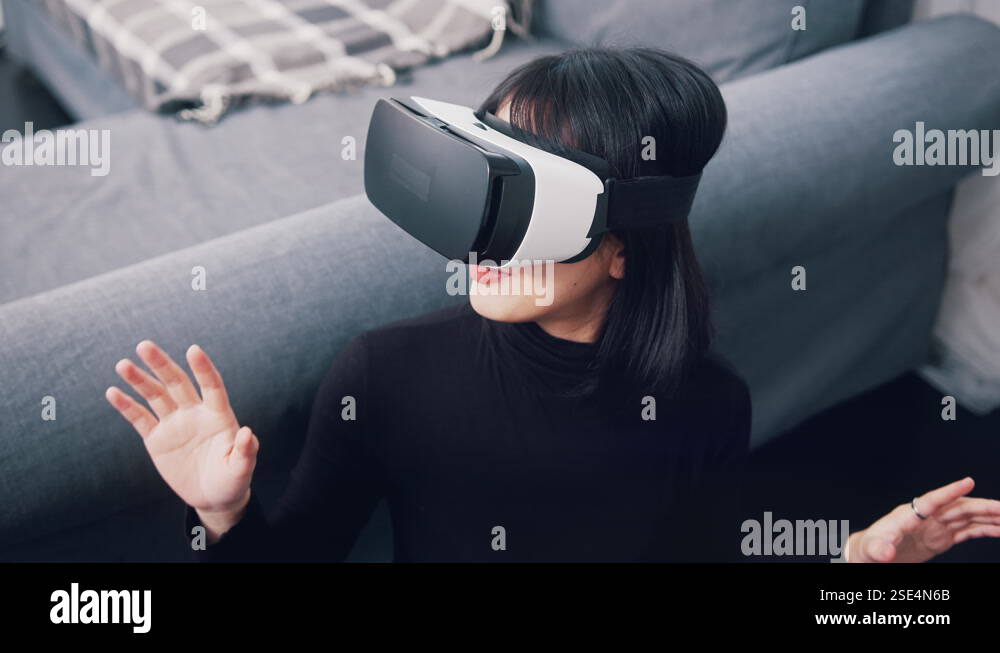 Young asian woman with VR headset experiencing virtual reality for the first Stock Video Footage ...