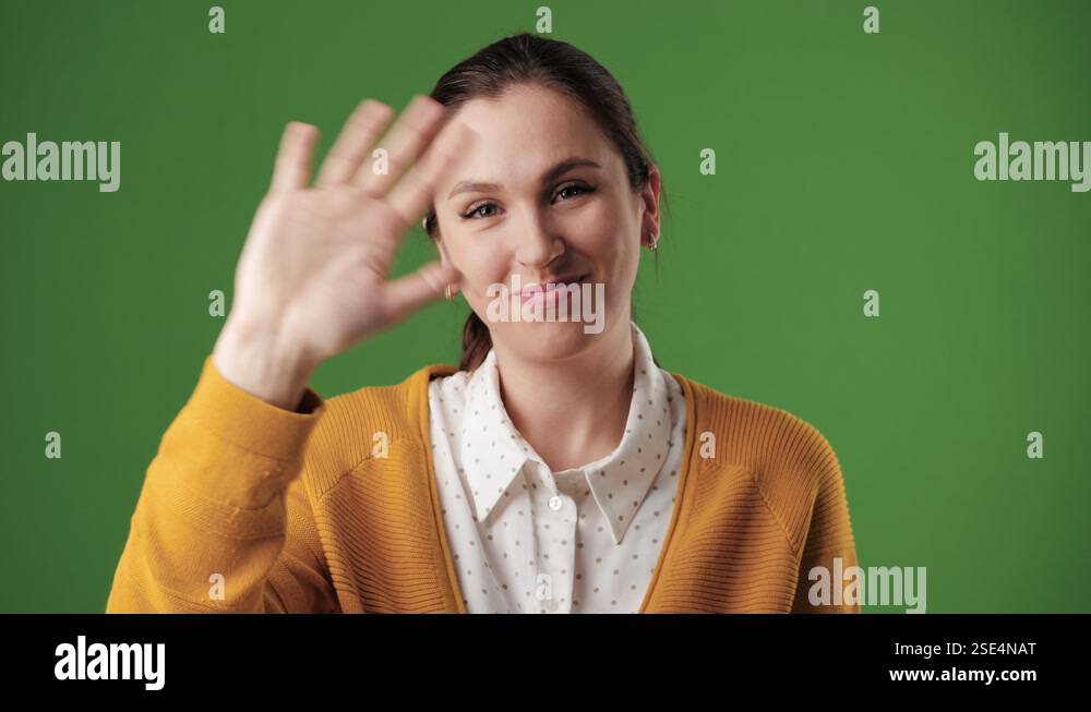Woman shows hello. Positive smiling woman on chroma key background ...