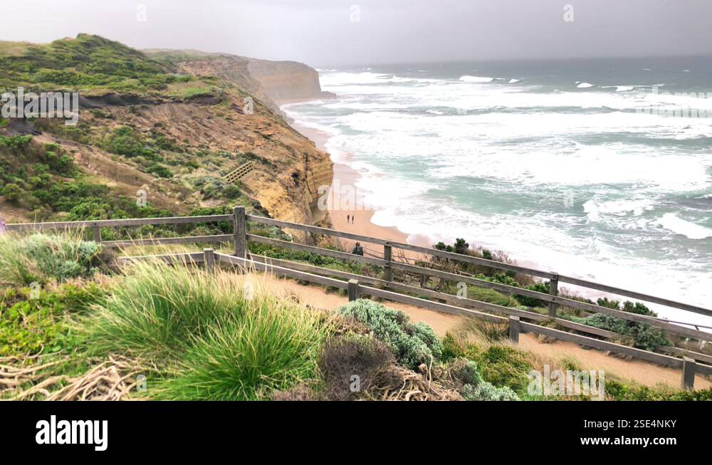 Woman going down at Gibson Steps, The Twelve Apostles at sunset. The ...