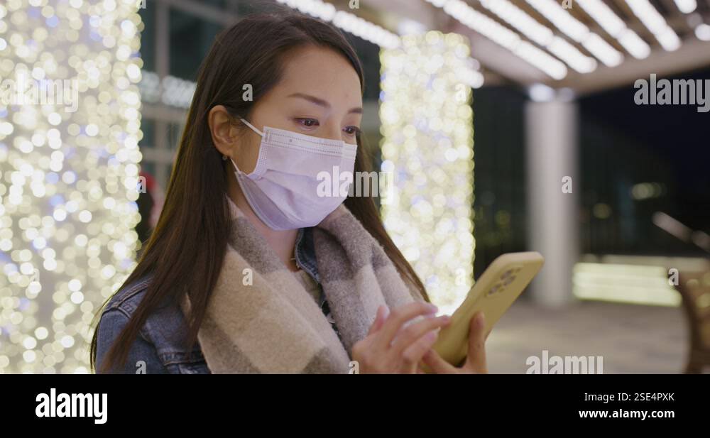 Woman wear face mask and use of cellphone at night Stock Video Footage ...