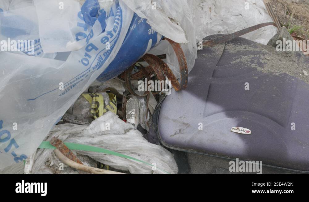 cinematic slider shot revolving around a pile of garbage at a local ...