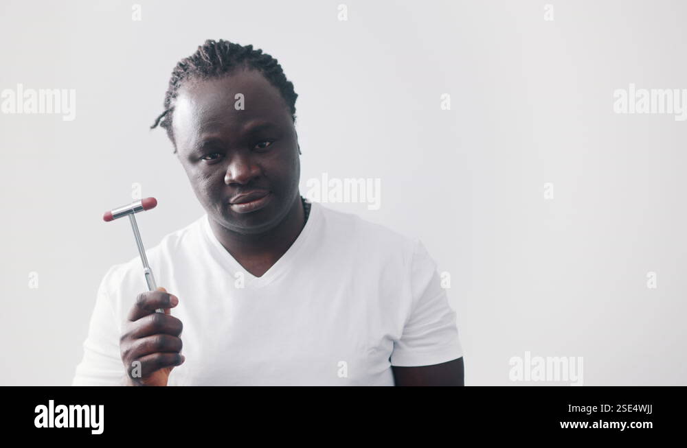 African american black man holding medical reflex hammer. Isolated on ...