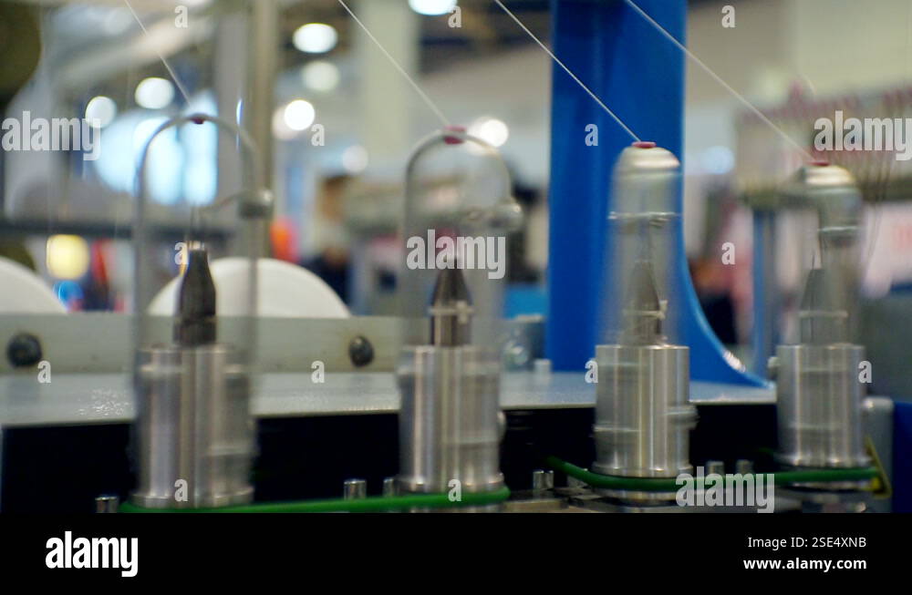 several threads are pulled through the rotating parts of the textile ...