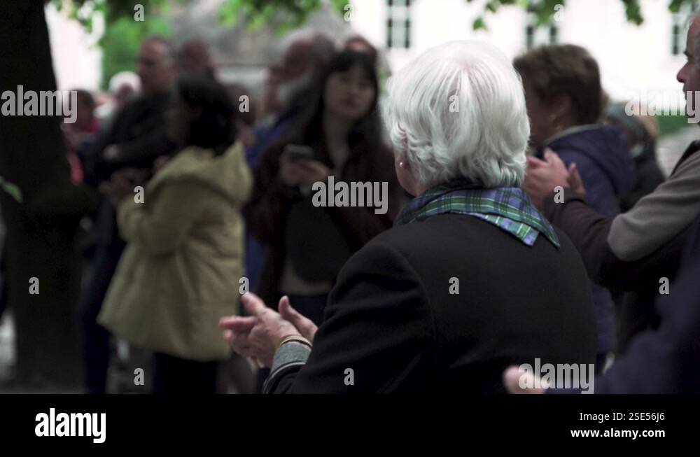 Elderly Woman Clapping Hands At The Park Near Mozart House In Salzburg ...