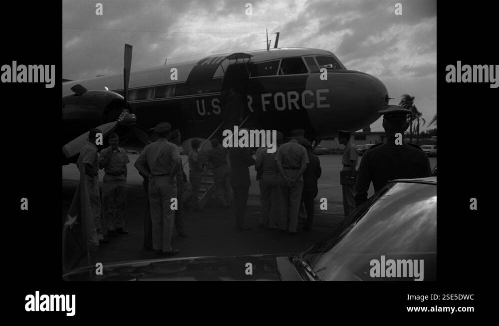 1960s: military officer stepping off plane and shaking hands before ...