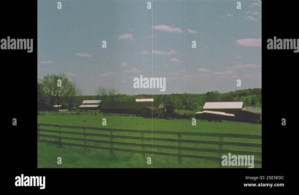 1970s: Farmland. Fountain and trees with skyscraper in background Stock ...