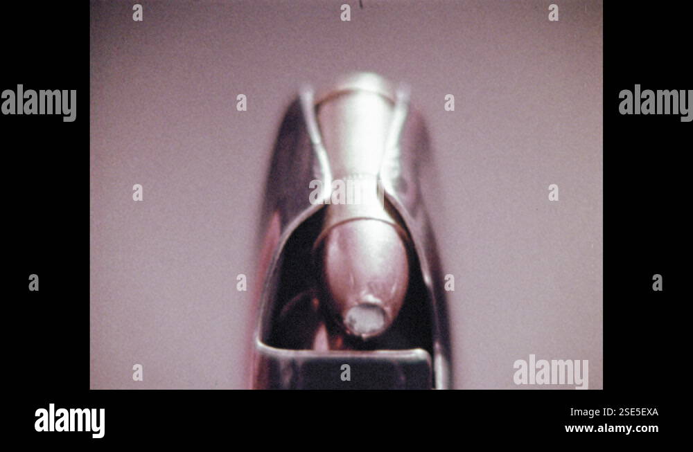 1970s: The bent top of an ammunition magazine full of bullets. The ...