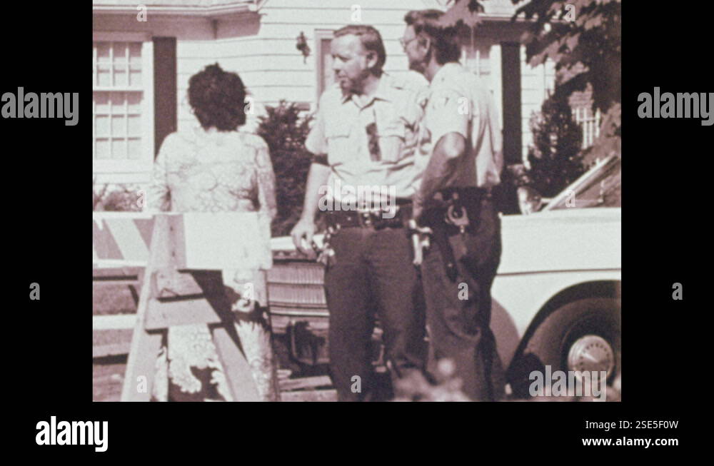 1970s: Still of cop's gun holster. Still of two cops talking to woman ...
