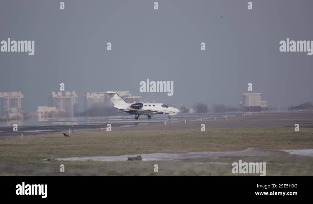 Business jet (bizjet or private jet) is taxiing on the runway before ...