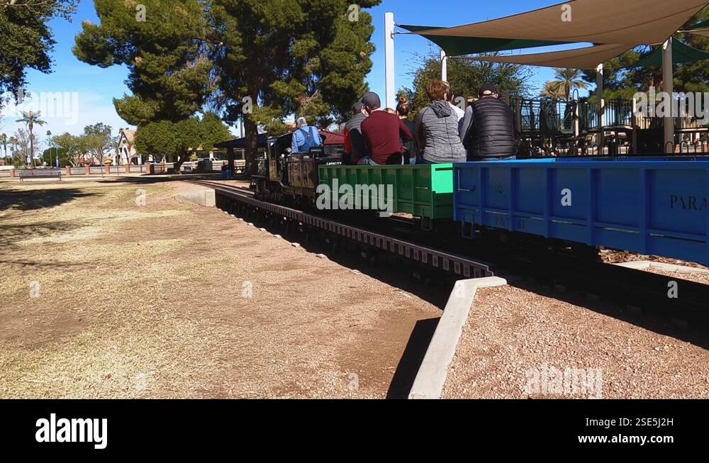 Low angle of Engine #11 pulls narrow gauge railroad cars full of ...
