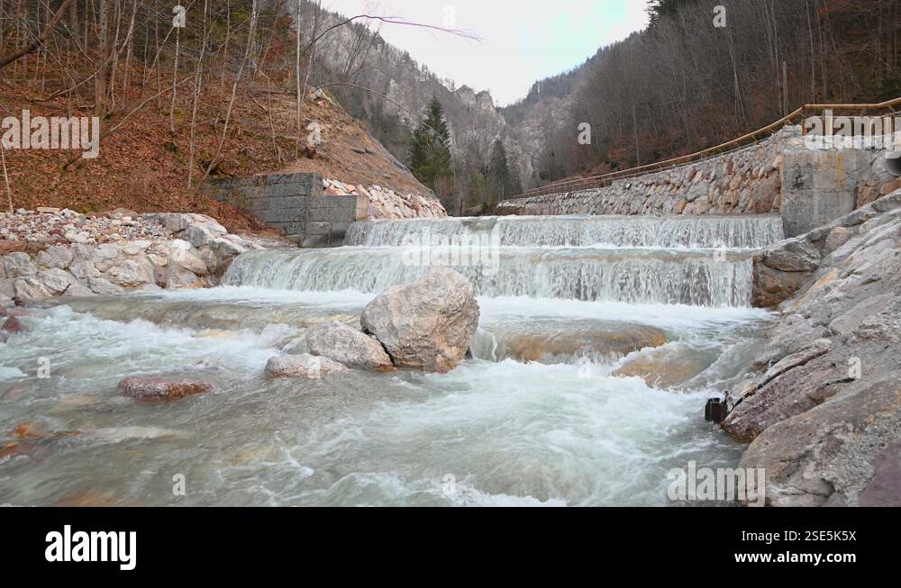 Water flowing over man made cascades in Alps mountains Stock Video ...