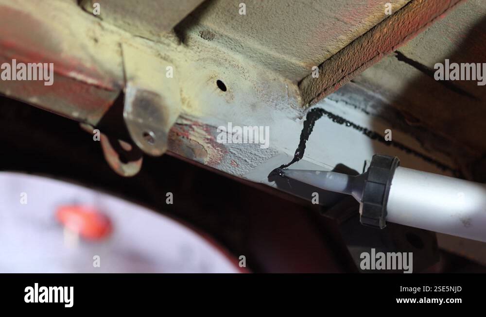 sealing of welded seams of a car with a sealant, body repair of ...