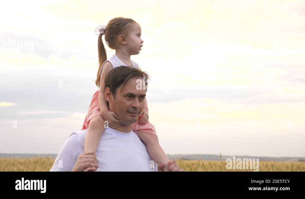 Dad carries on shoulders of his beloved child, in rays of sun. Father walks with Stock Video ...