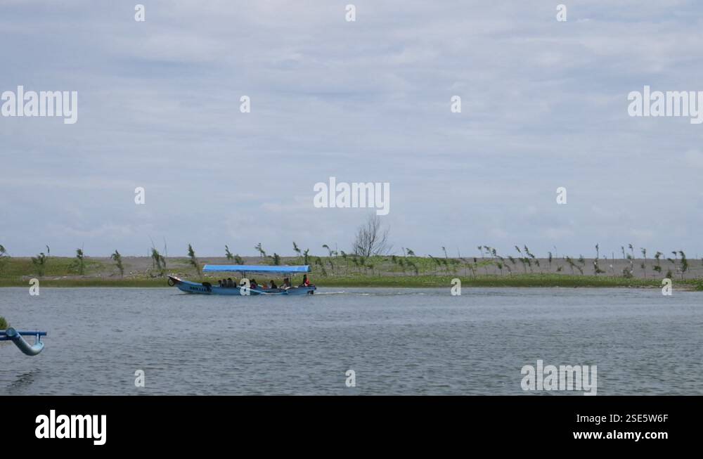 A visitor's boat crosses a lagoon in a coastal area in Yogyakarta Stock Video Footage - Alamy