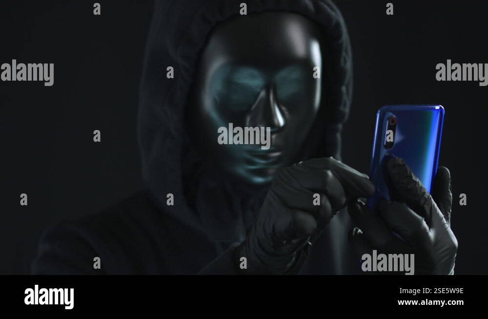 Hacker wearing dark mask pulls NFT of Non-Fungible Token text tab out ...