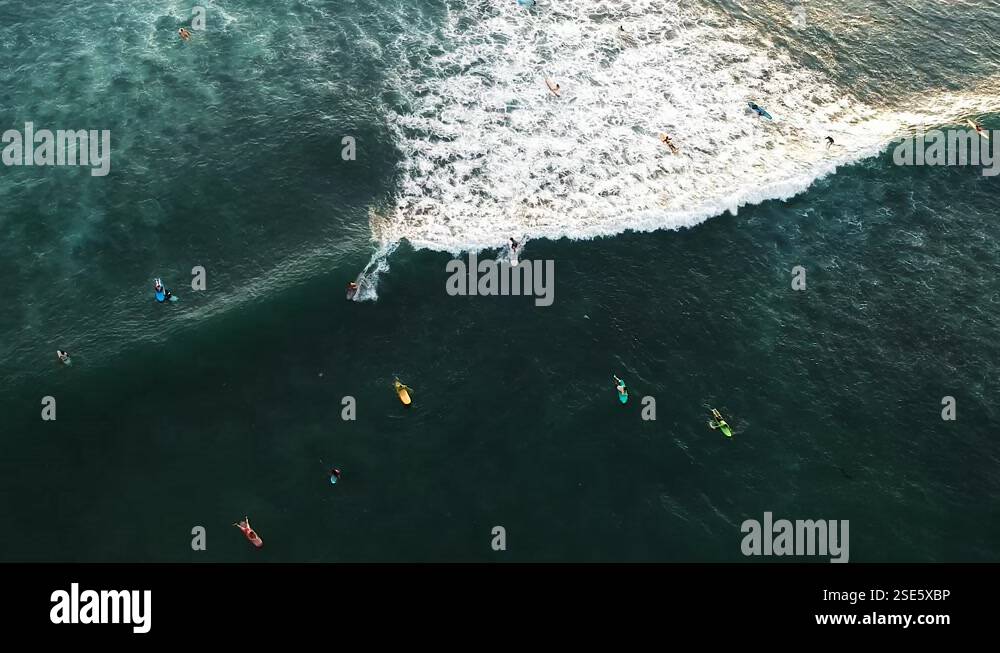 Many surfers catching large waves off the coast of echo beach in Canggu ...